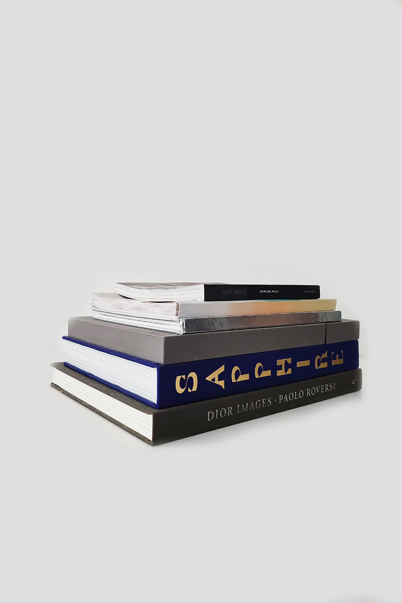 Stack of luxury fashion coffee table books – ProppedUpRentals